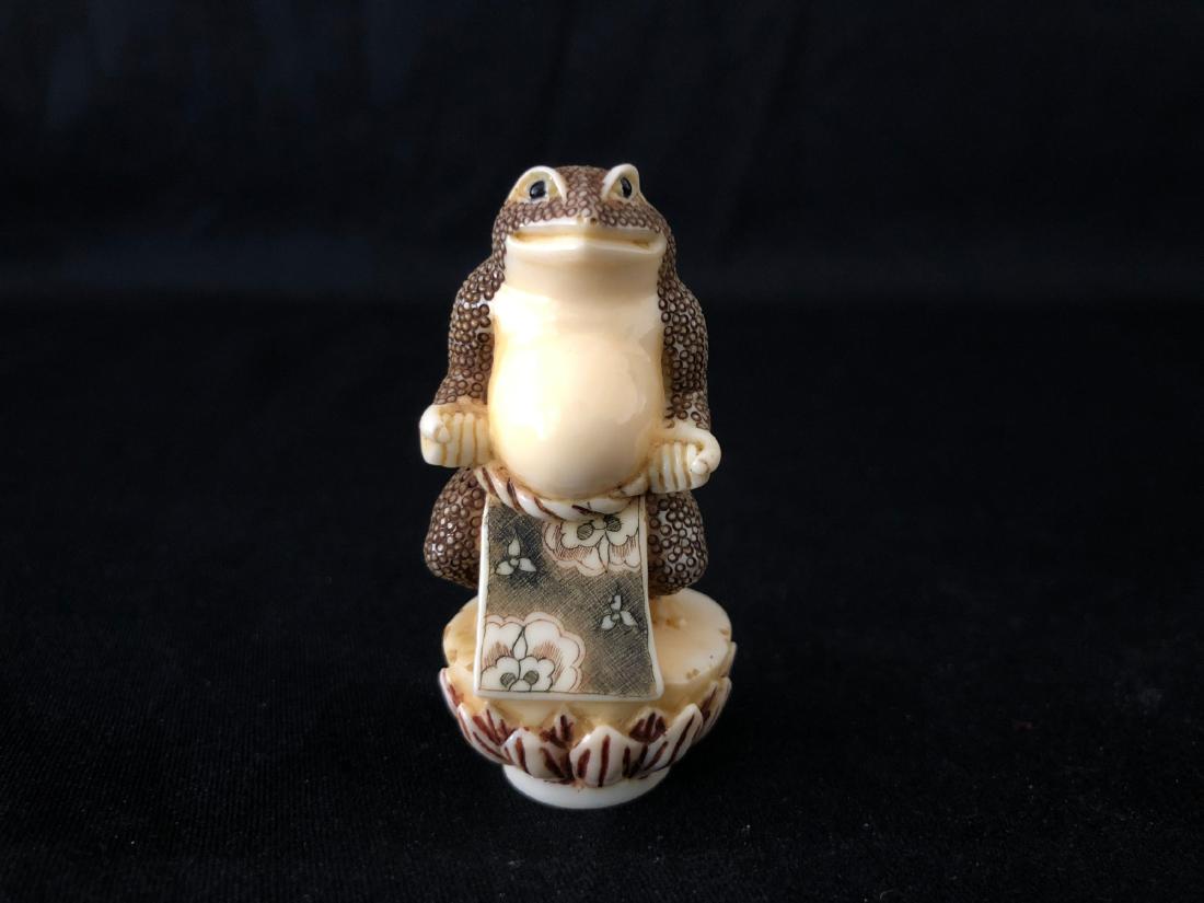 A Cattle Bone Carved Netsuke Of Toad On Lotus