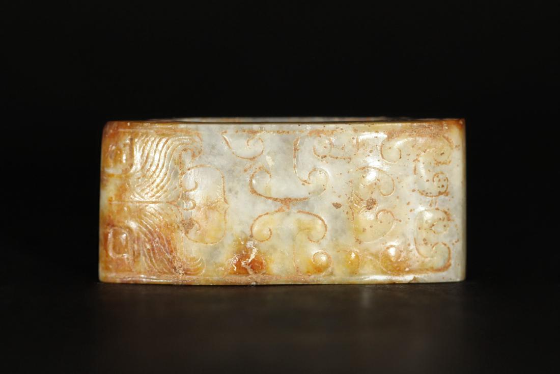 A WHITE AND RUSSET JADE SWORD SLIDE HAN DYNASTY