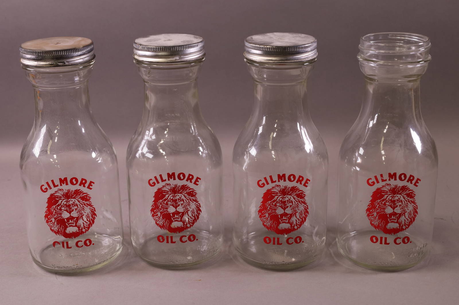 Four Reproduction Gilmore Oil Bottles Auction