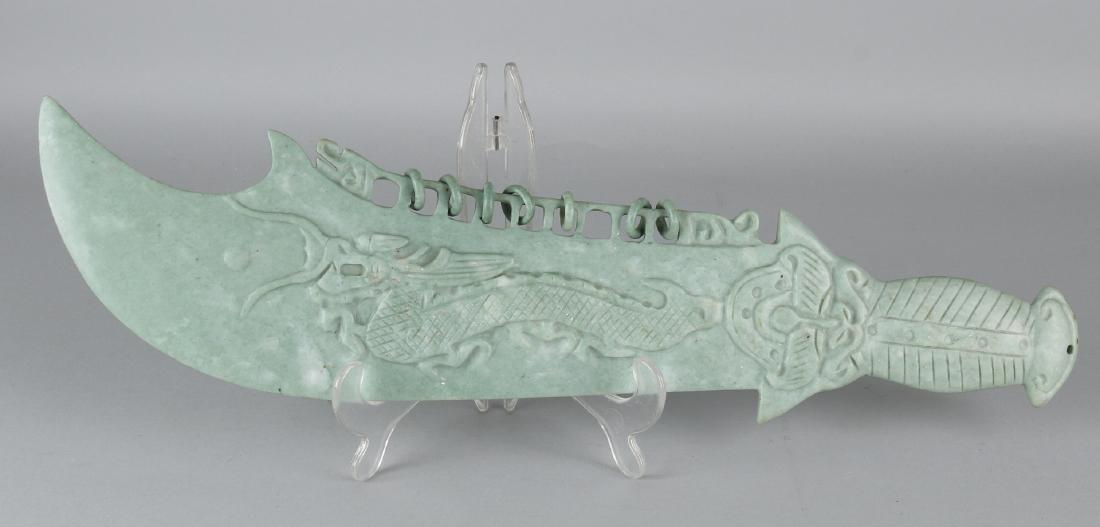 Big old Chinese jade sword with dragon and rings.