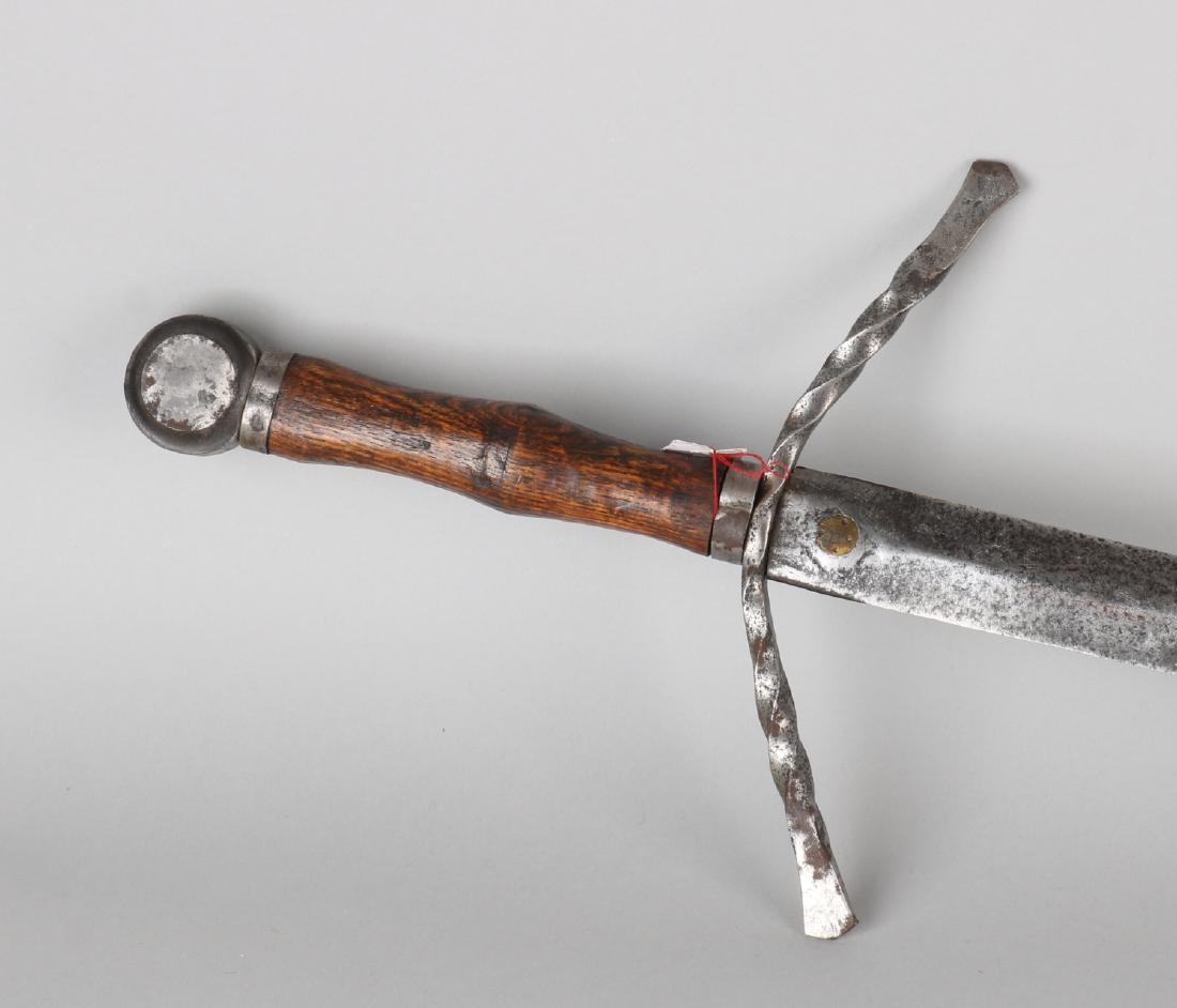 Antique English sword. Marked with bronze medallion in