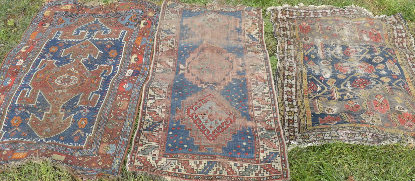 Three Antique Worn Scatter Rugs.