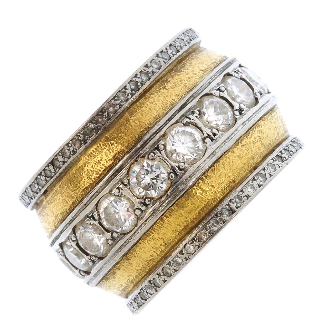 A diamond band ring. Of bi-colour design, the