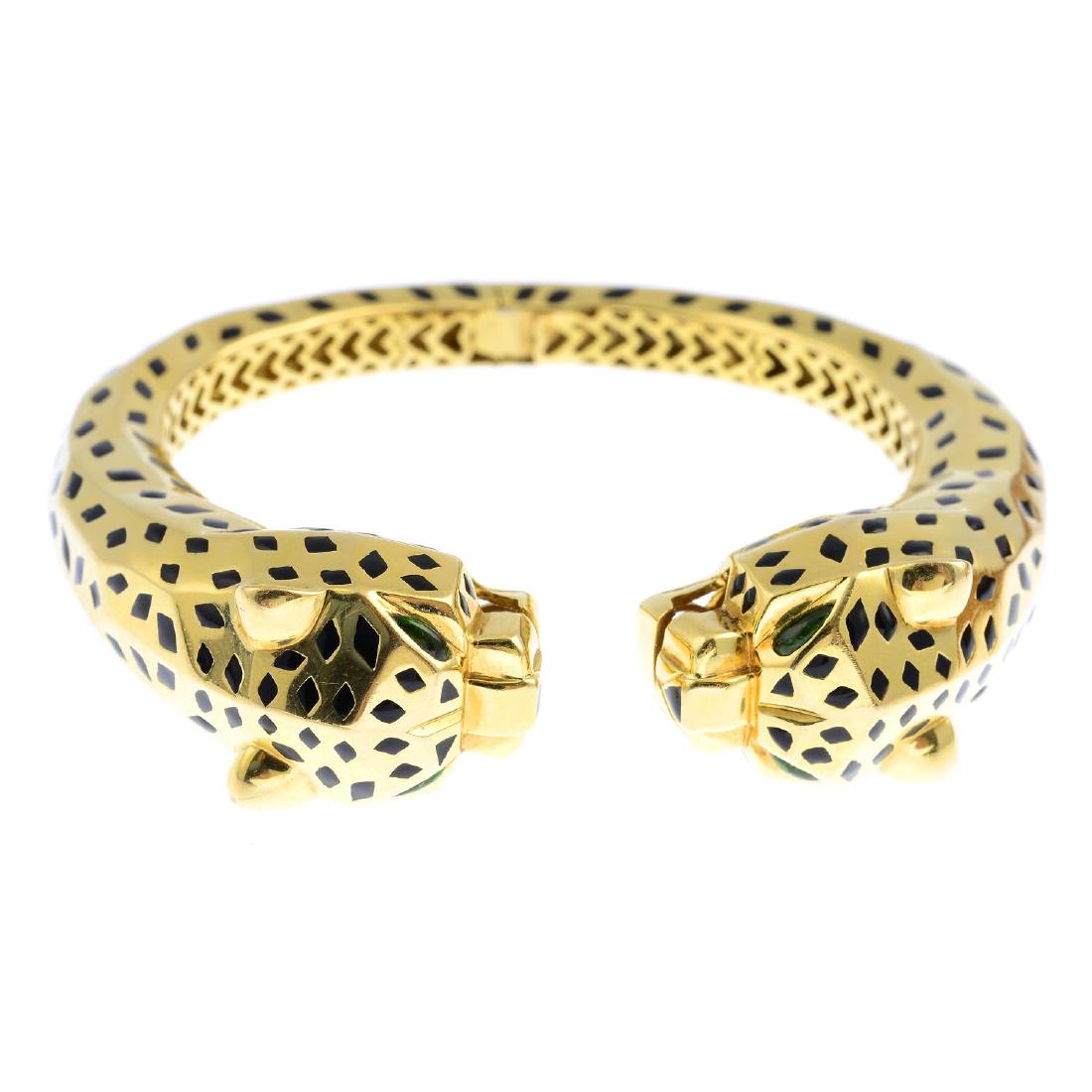 An enamel and gem-set leopard hinged bangle. The cuff