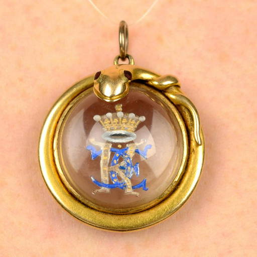 A late 19th century 18ct gold snake locket, the rock crystal reverse ...