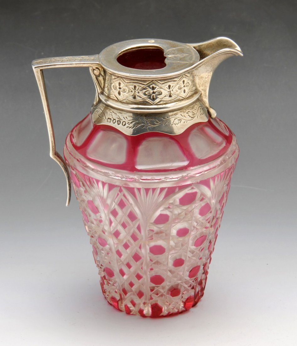 A Victorian silver mounted overlay glass cream jug.