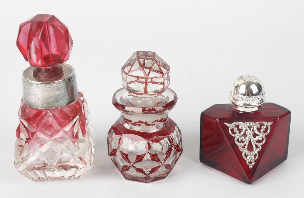 Three red glass scent bottles