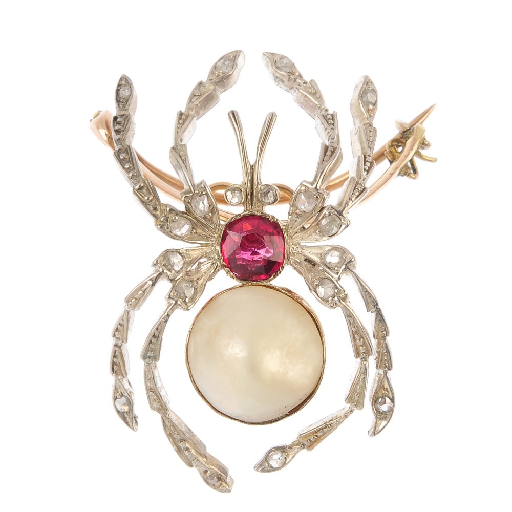 A gem-set spider brooch. The circular-shape red spinel