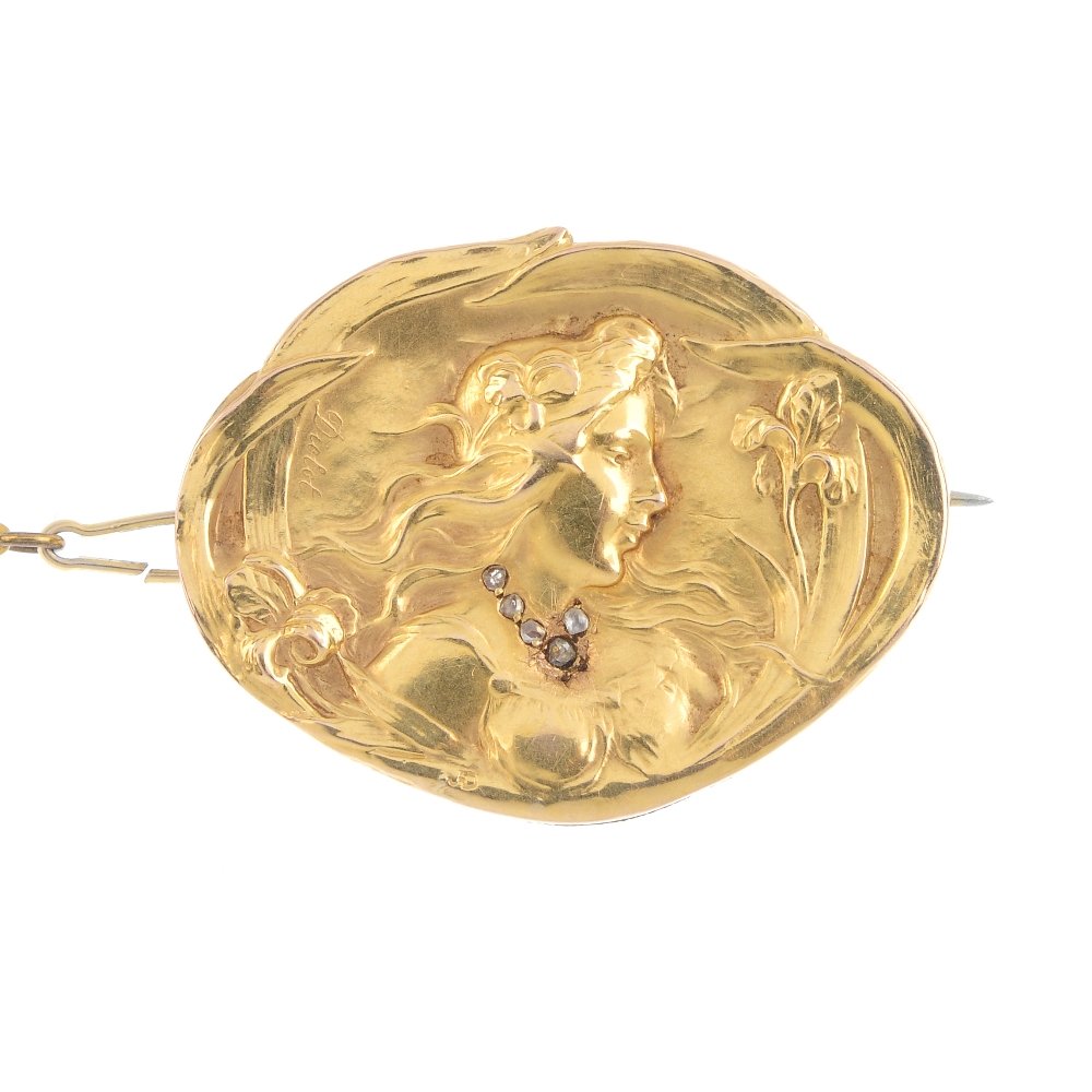 An Art Nouveau gold diamond brooch. Of oval outline,