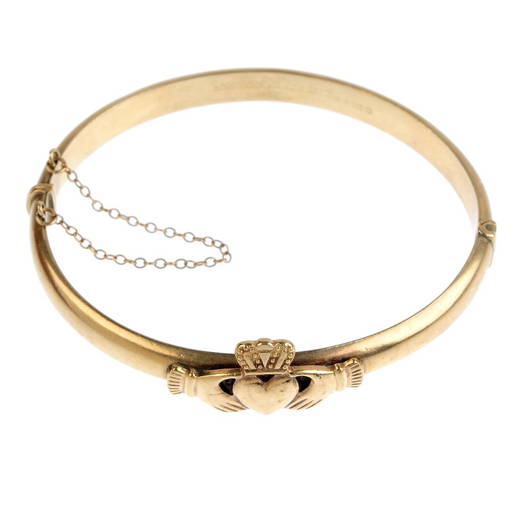 A 9ct Gold Claddagh Bangle. The Claddagh Overlaid To