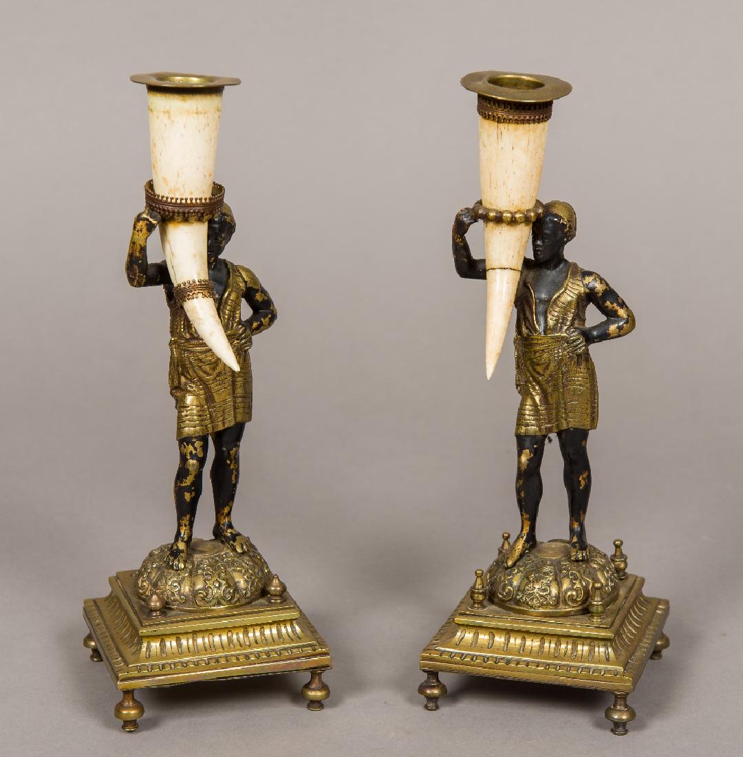 A pair of 19th century Blackamoor form candlesticks