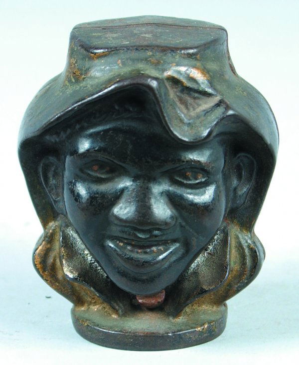 335: Cast Iron Two-Faced Boy Still Bank manufactured by