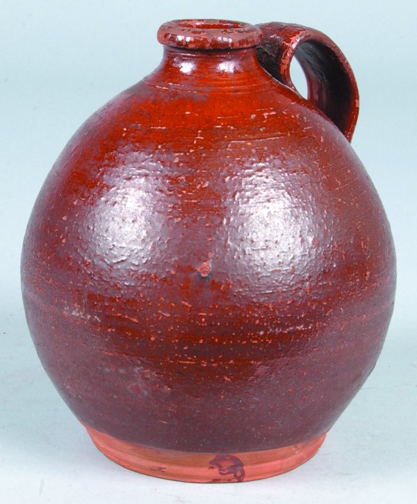 378: Redware Bulbous form Jug with applied handle and m