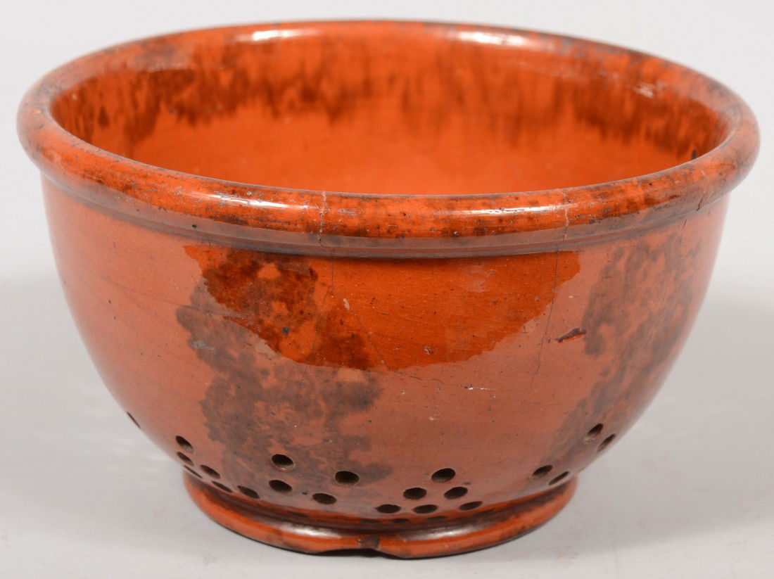 67: Glazed Redware Colander. Manganese splotches decora