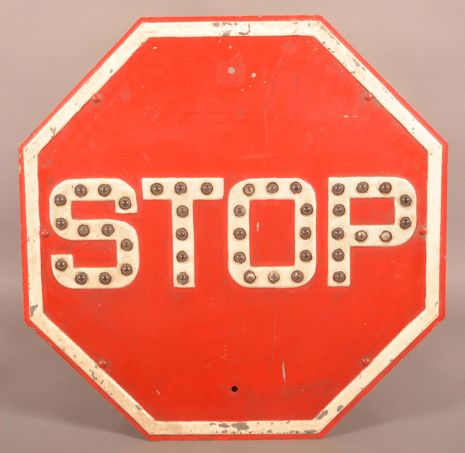 Red Metal Stop Sign With Glass Reflective Marbles.