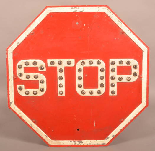Red Metal Stop Sign With Glass Reflective Marbles.