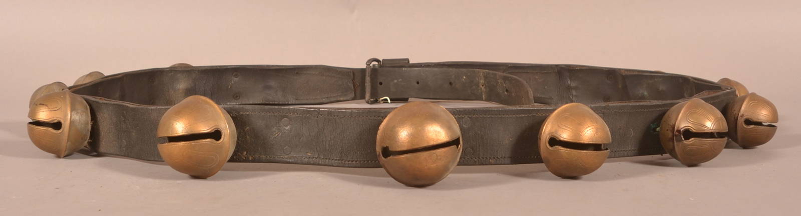 String Of 13 Antique Incised Brass Sleigh Bells. Auction