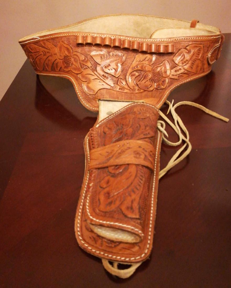 Hand tooled leather pistol holster and ammunition belt