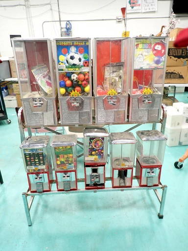 9 Commercial Gumball Machines On A Rack