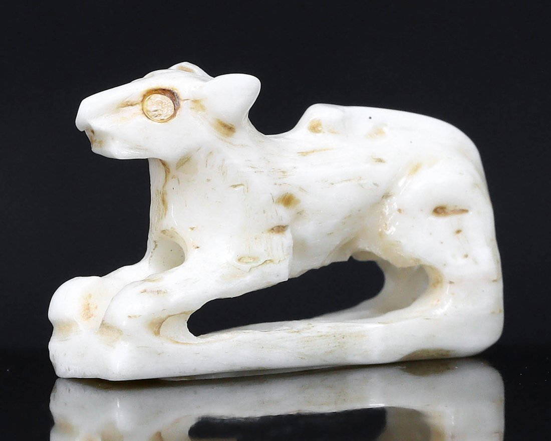 An Alabaster Amulet Of A Recumbent Animal Auction