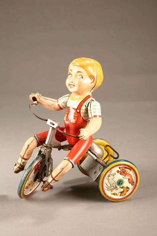 1019: TIN WIND UP TOY. Kiddie Cyclist" by Unique Toys.