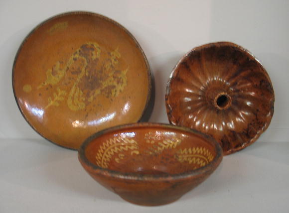 Three Pieces Of Redware. Pictured Is A Fluted Food