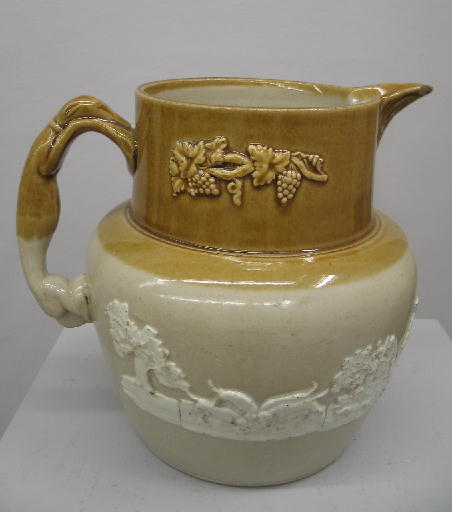 Hound Handle Pitcher. Putty Glaze With Amber Glaze