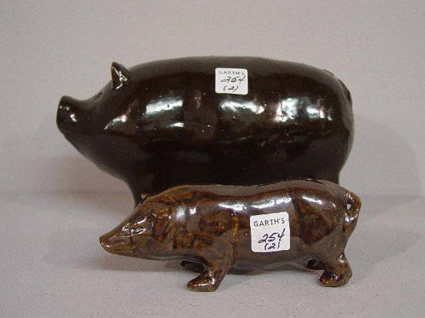 Two Pottery Pigs. Larger Has Albany Slip And Hand