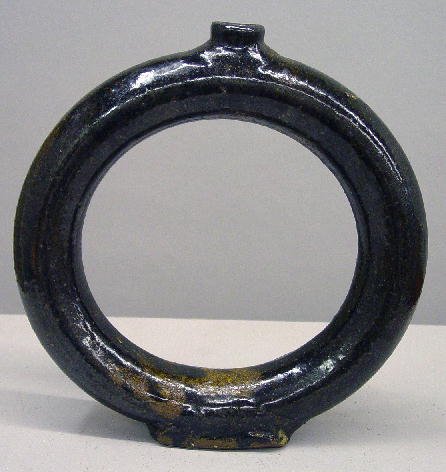 603: LARGE DONUT OR RING FLASK. Redware with thick mang
