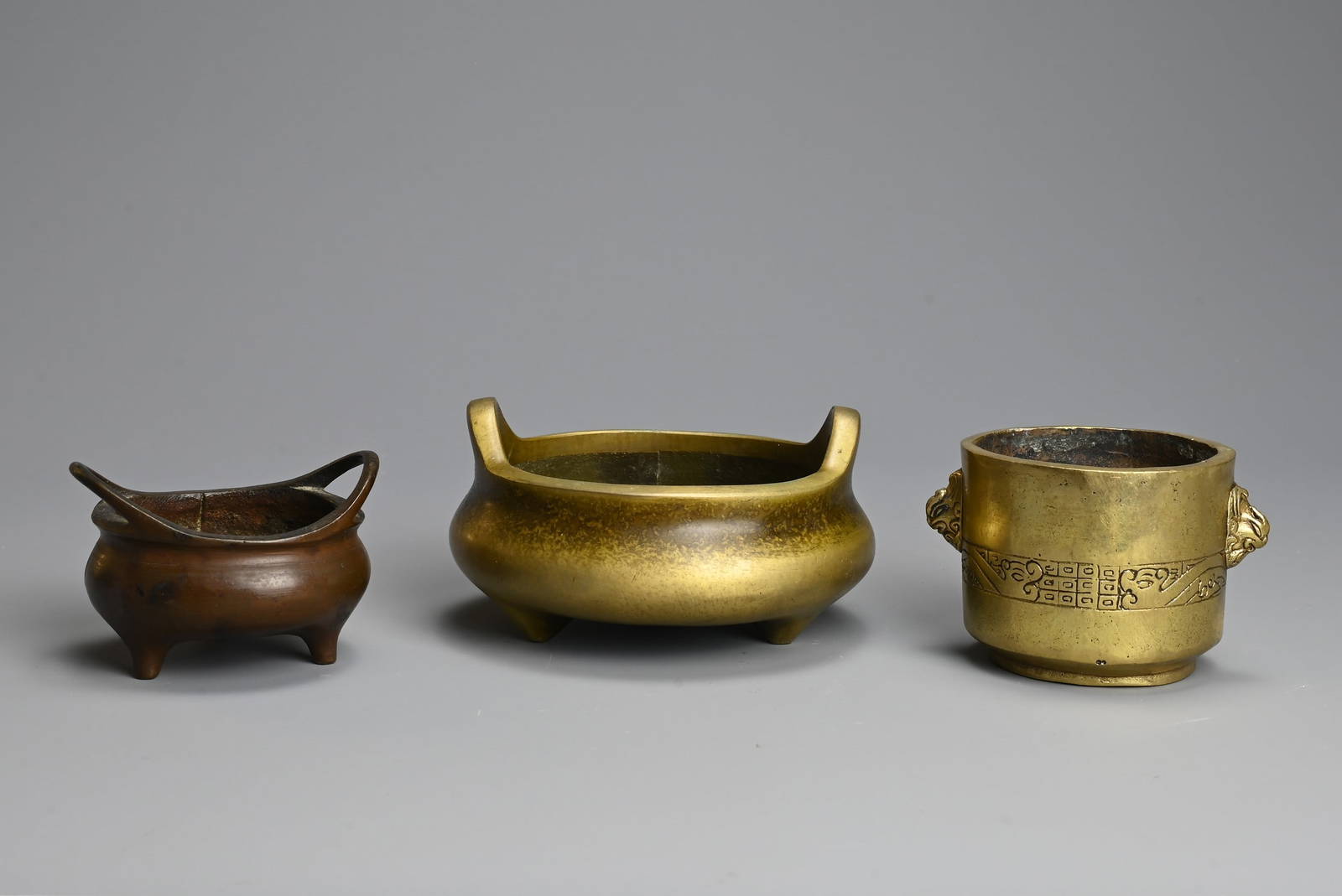 Three Chinese Bronze Censers, 19/20th Century. The Largest Of Circular Form With Raised Handles ...