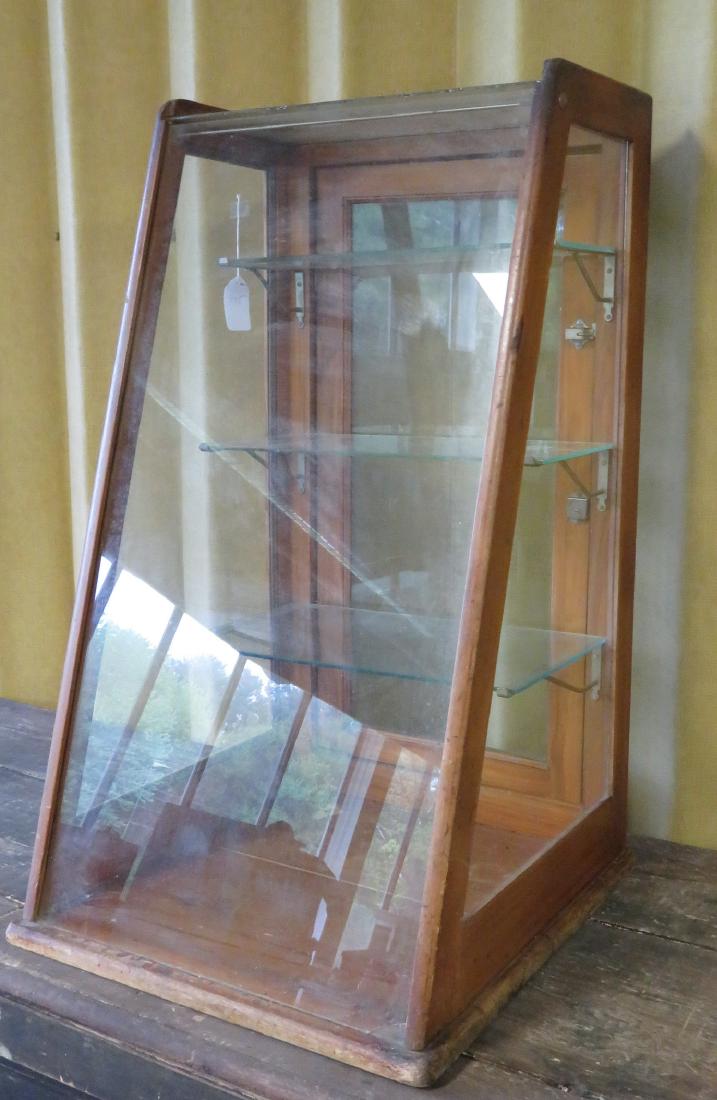 Counter top slanted glass showcase with maple frame