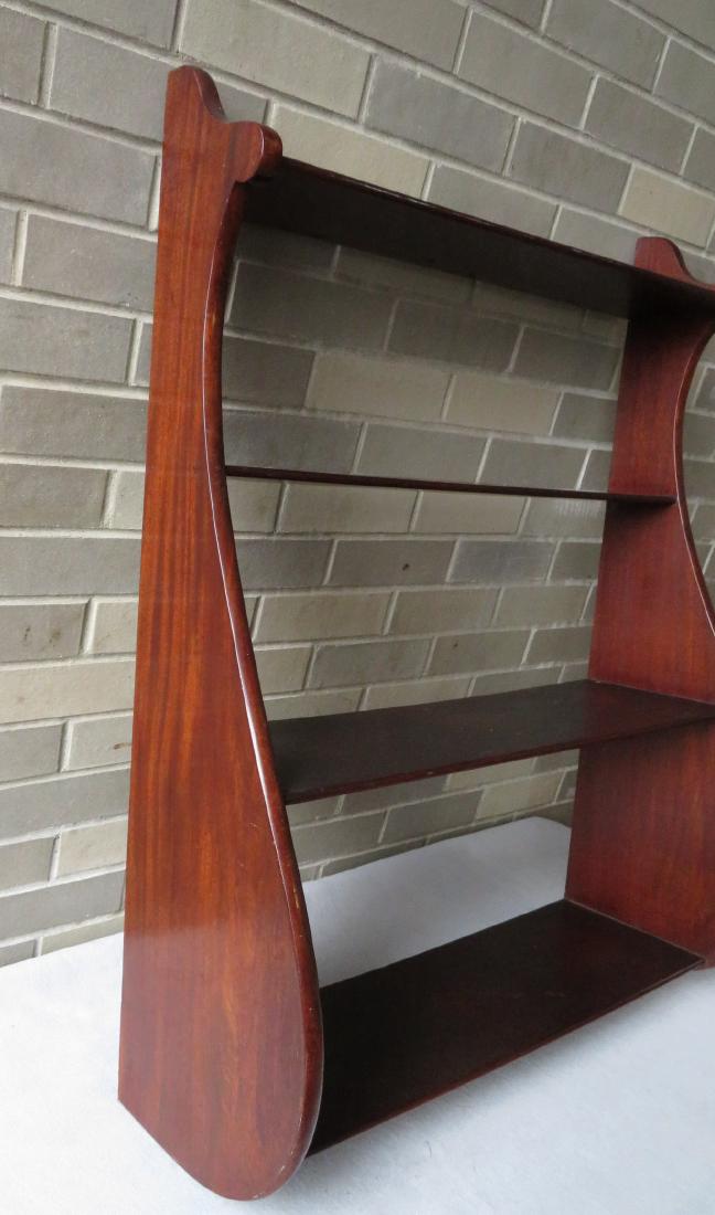 Whale's tail wall shelf in mahogany having 4 tiers