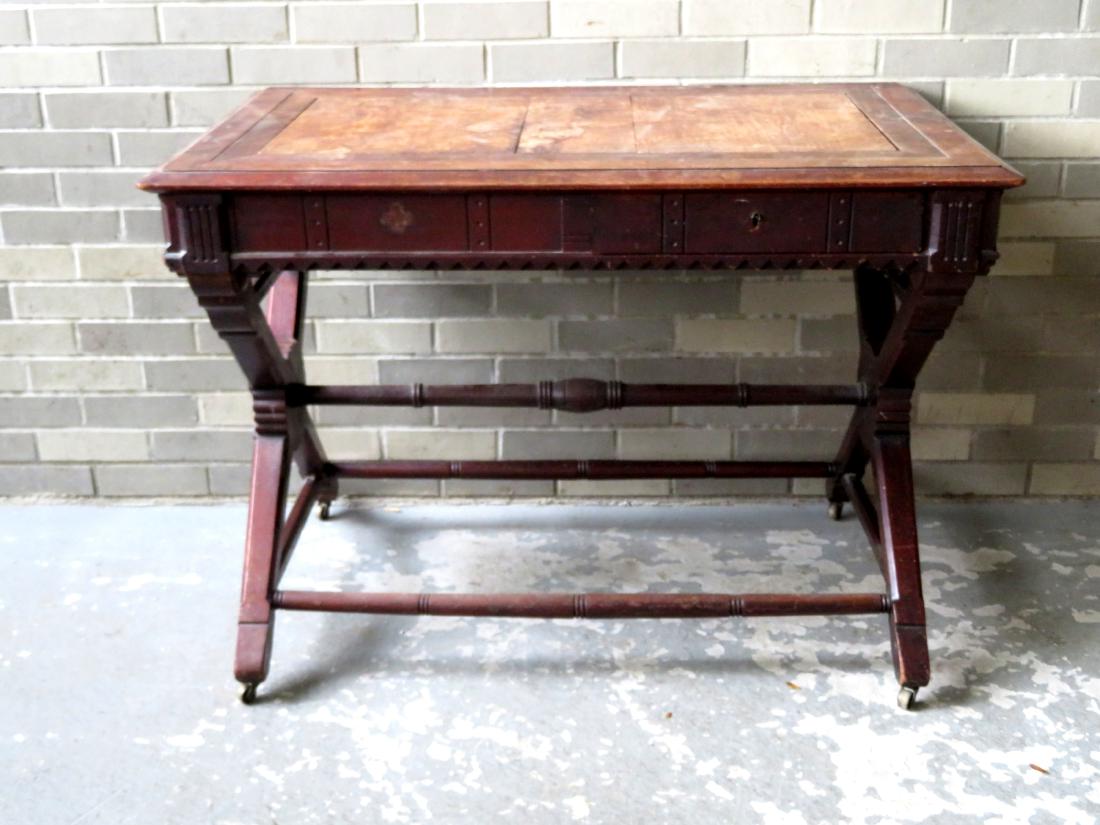 Victorian black walnut library table having ornate "X"