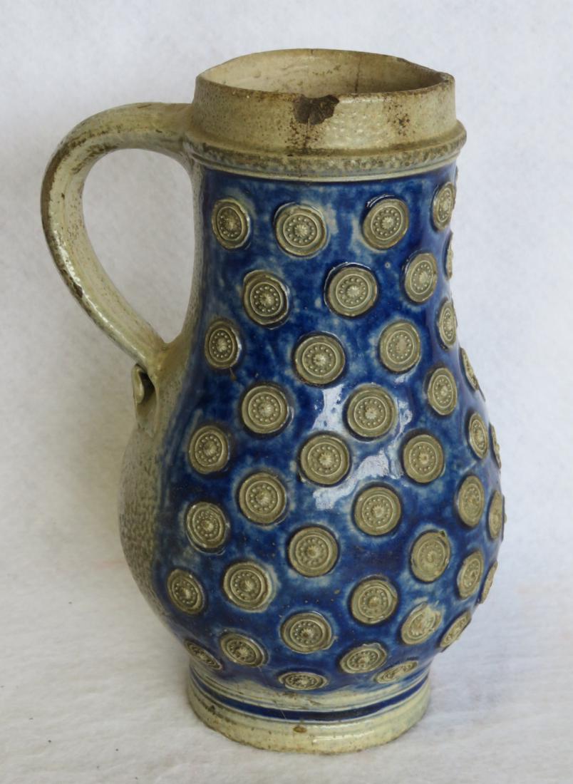 A Westerwald salt glazed stoneware jug decorated with