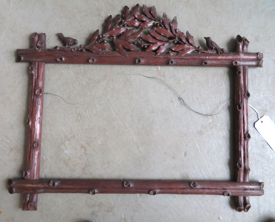 A folk art rustic carved wooden frame. The sides carved