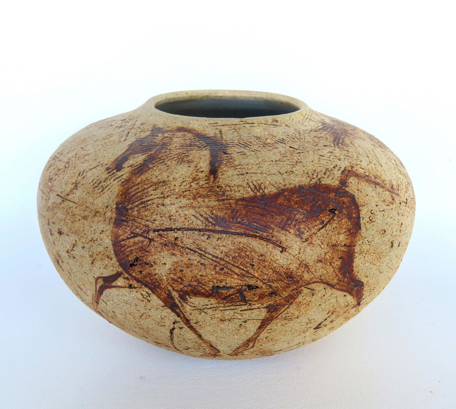 A pottery bowl decorated with horses and bison, and painted in the ...