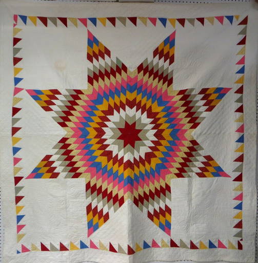Patchwork Quilt In The Texas Star Pattern With Saw Toot