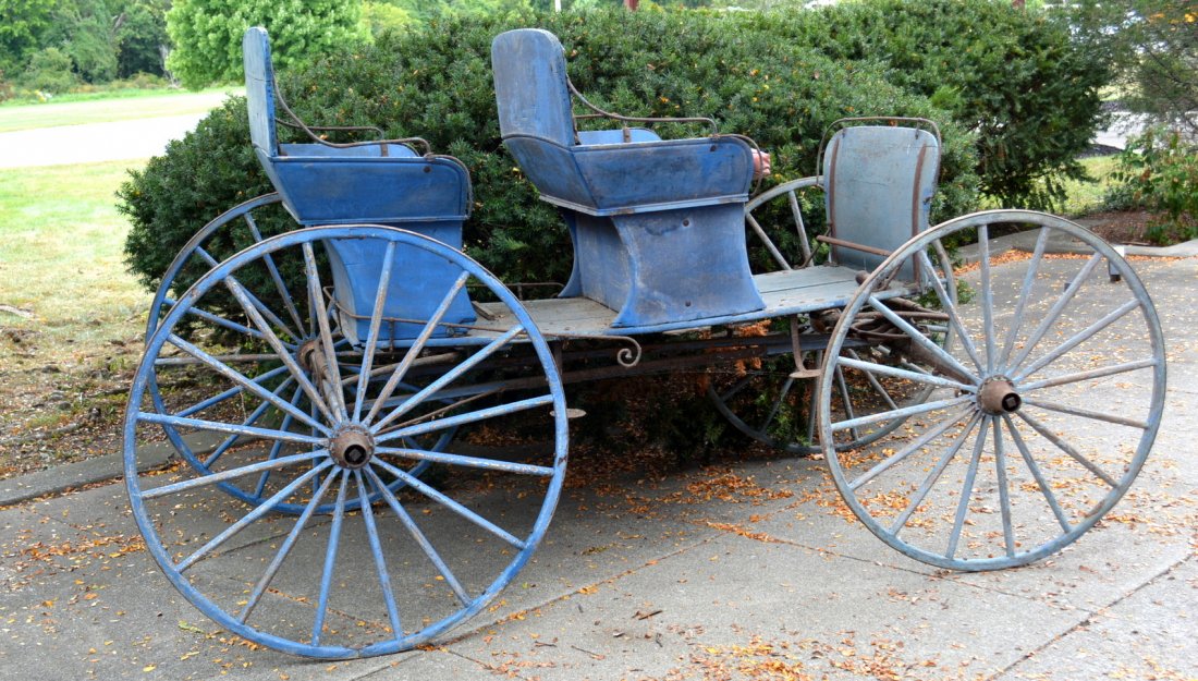 Horse drawn buckboard with wooden wheels, front and