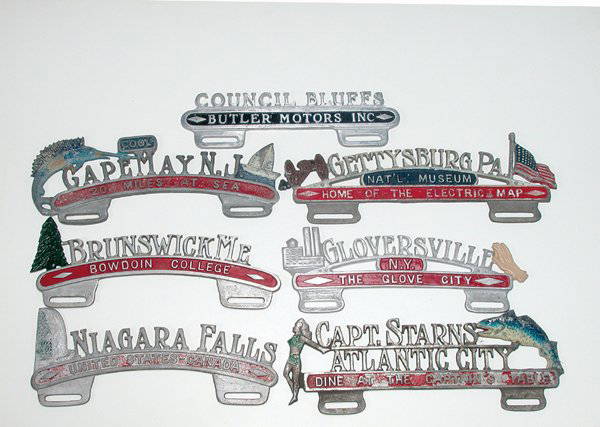 Seven Original Vintage License Plate Toppers