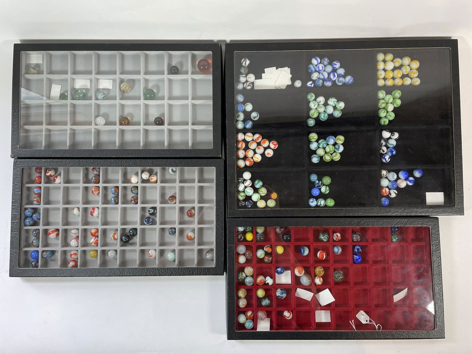 Four Display Cases Of Antique Marbles