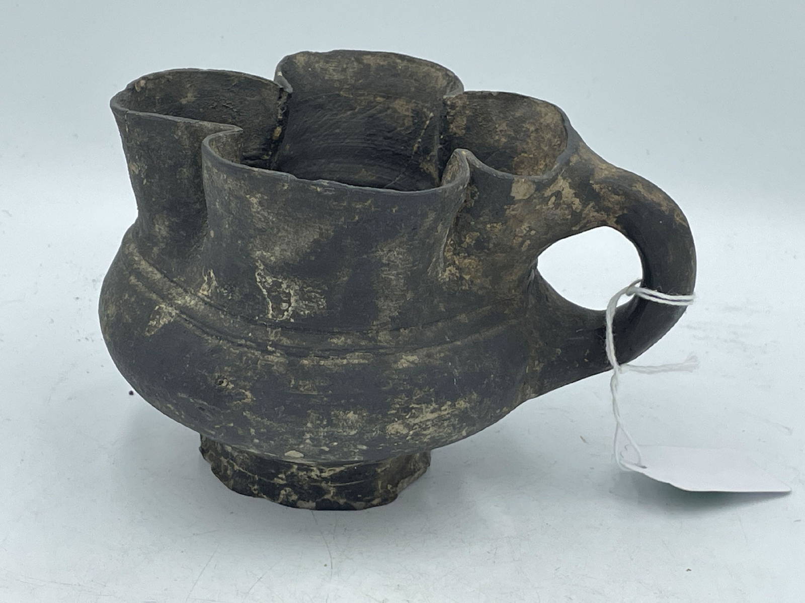 An Ancient Mug With Hole Repairs Auction