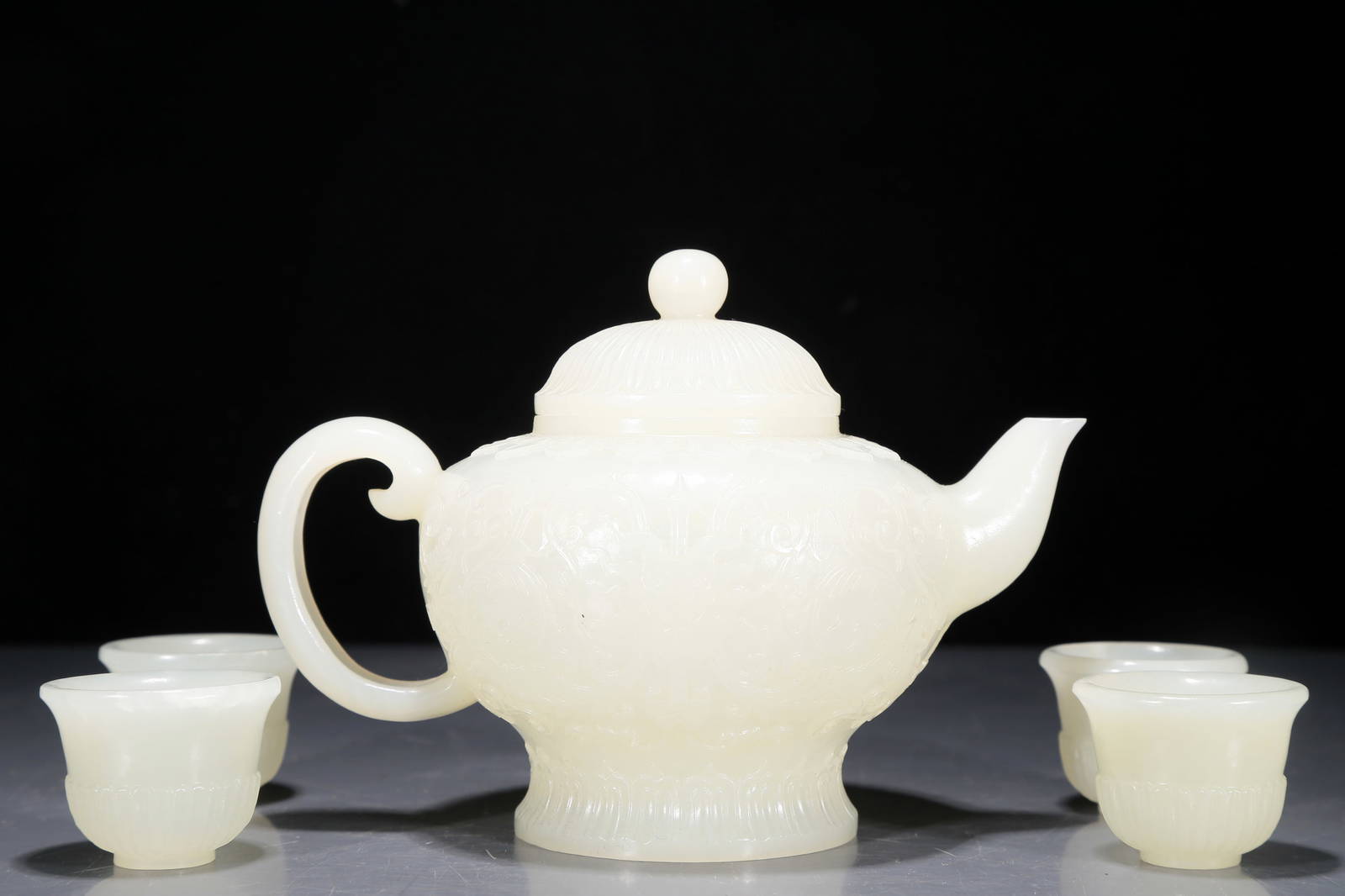 An Elaborate White Jade 'scrolling Lotus' Teapot With Four Teacups Auction
